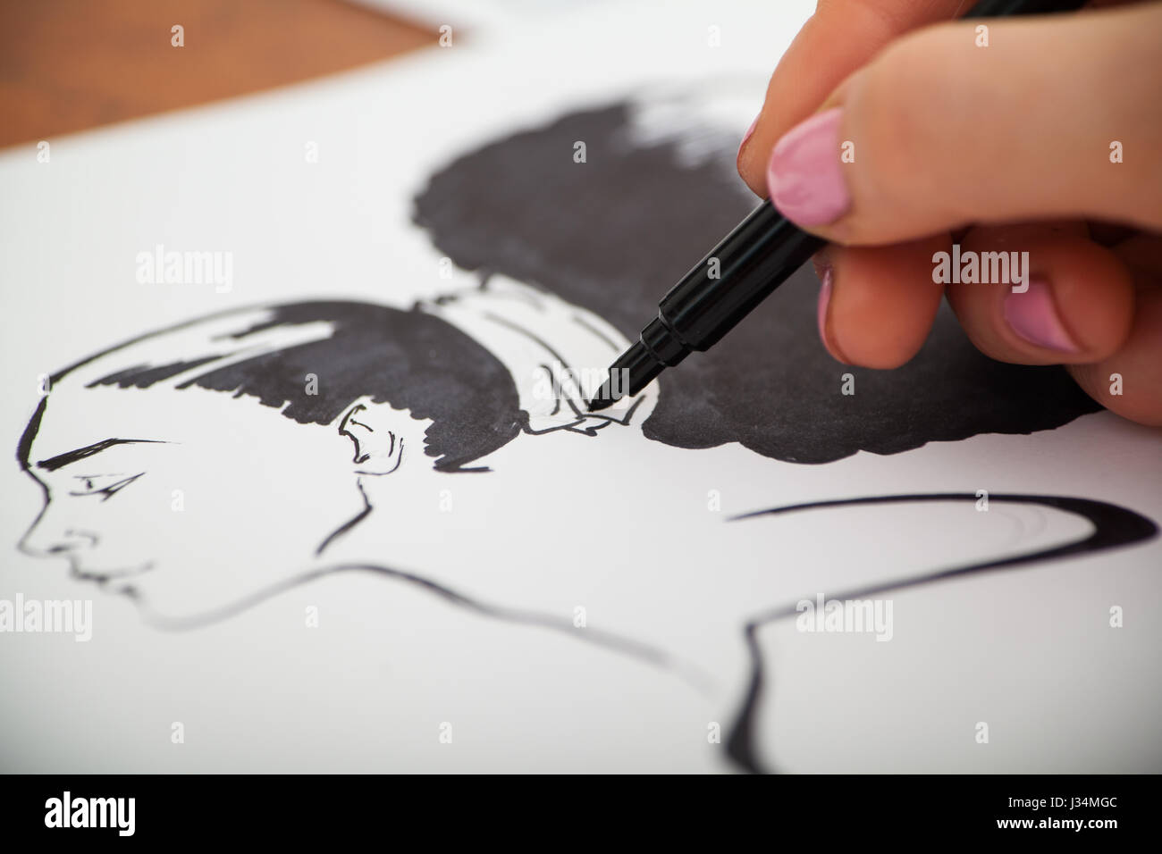 Closeup of drawing woman's portrait at the desk Stock Photo - Alamy