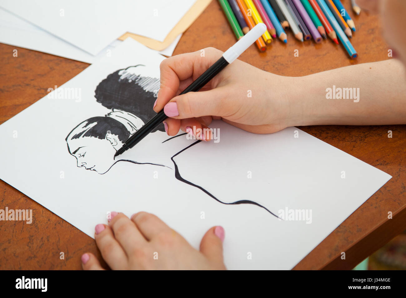 Closeup of drawing woman's portrait at the desk Stock Photo - Alamy