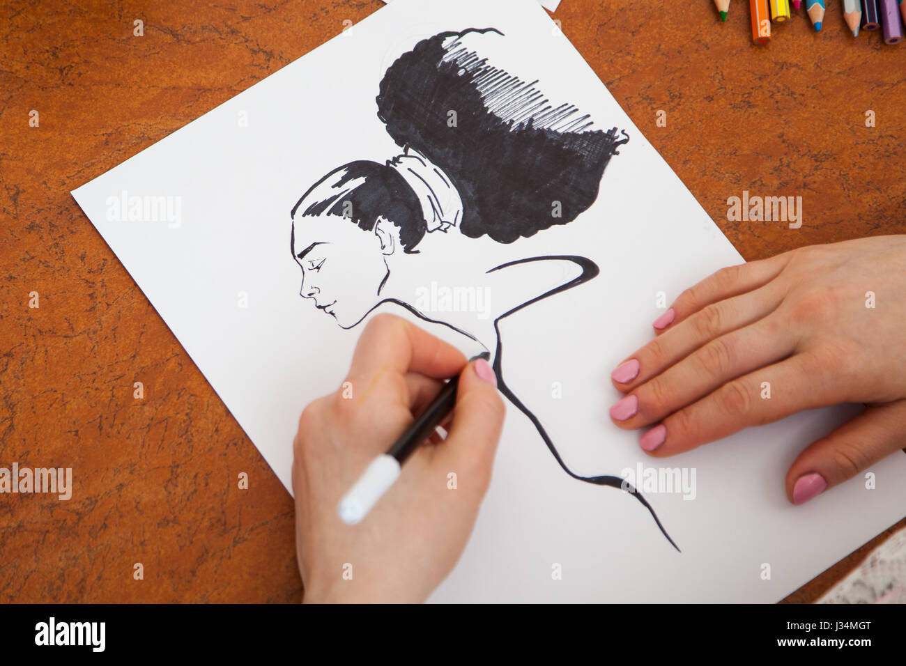 Closeup of drawing woman's portrait at the desk Stock Photo - Alamy