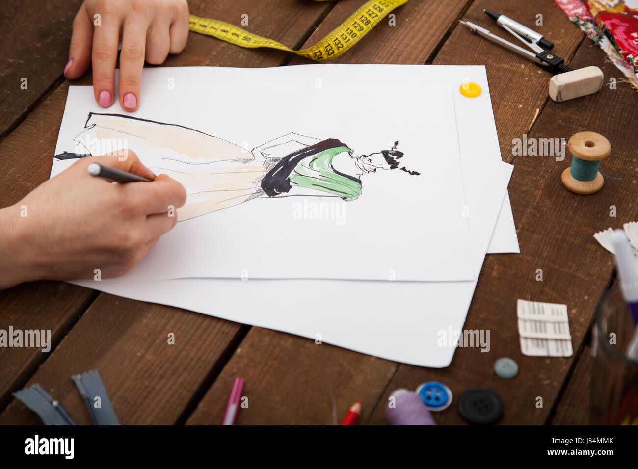Fashion designer drawing new models of clothes Stock Photo - Alamy