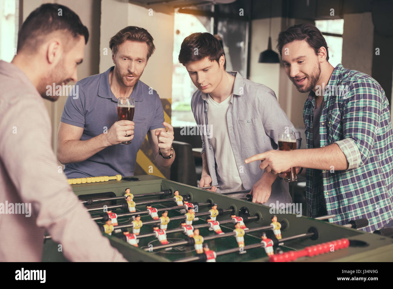Friends having fun in pub Stock Photo - Alamy