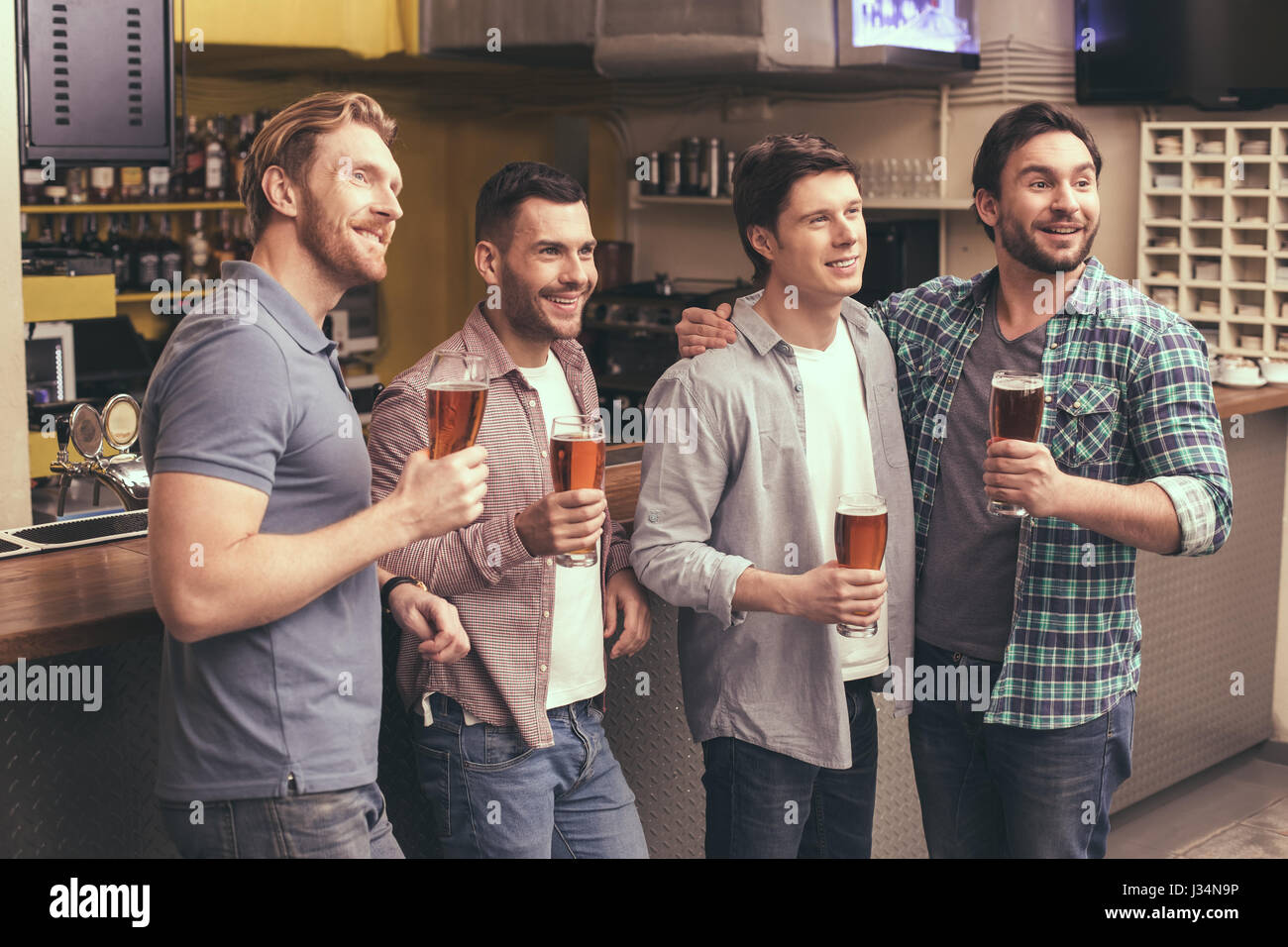 Friends having fun in pub Stock Photo - Alamy