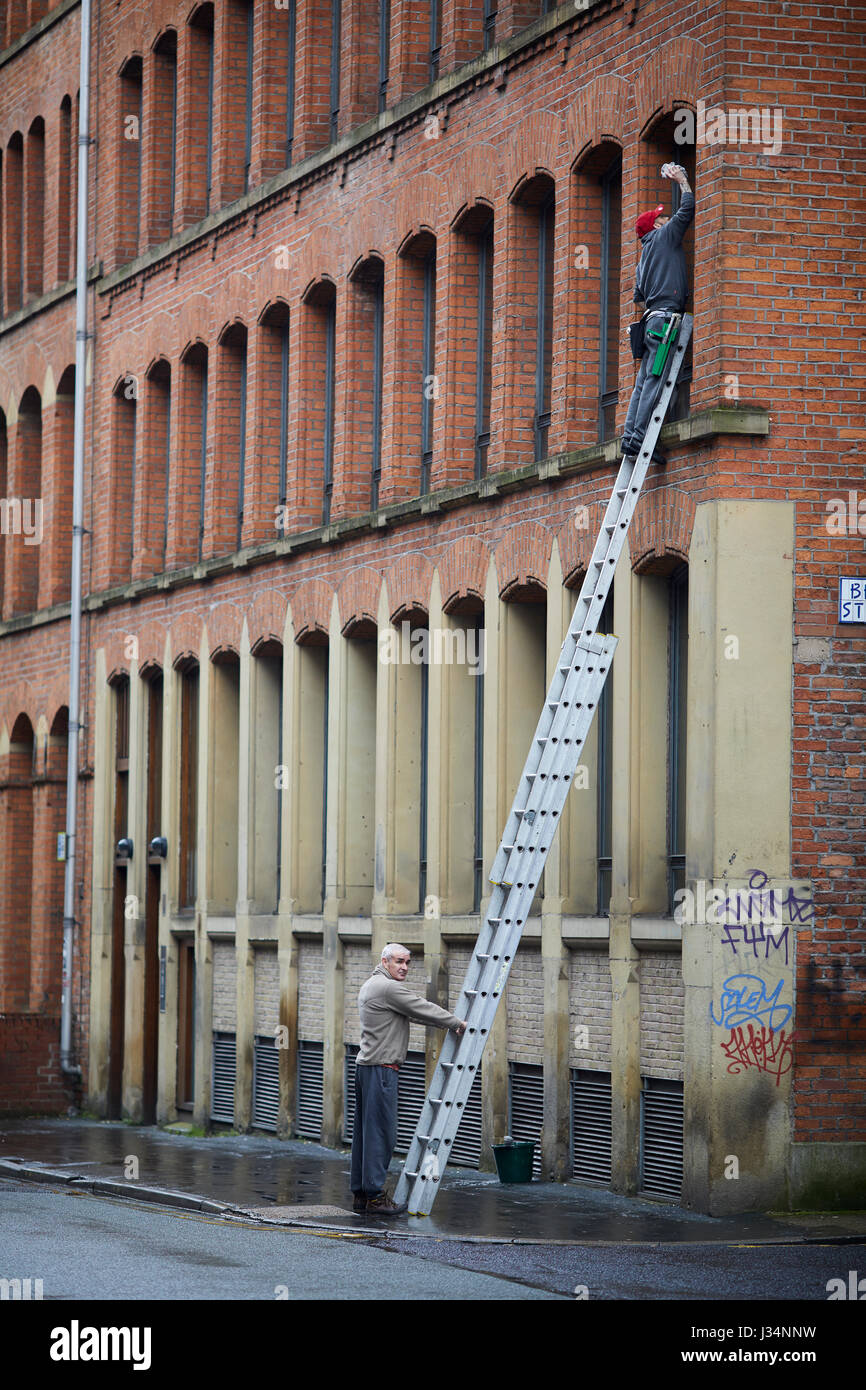 Manchester city centre apartment window cleaner on ladders Stock Photo ...