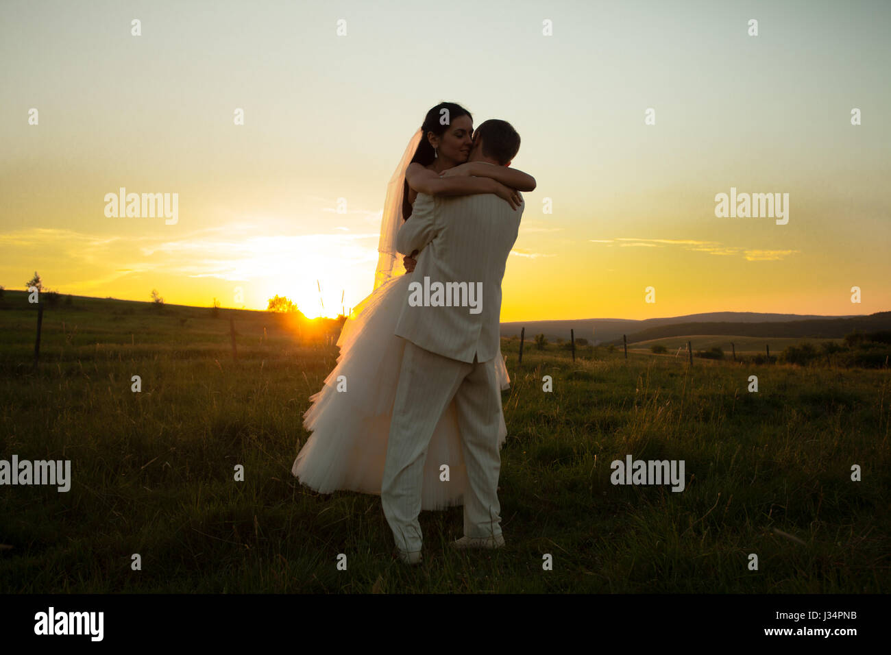 Wedding couple on sunset Stock Photo - Alamy