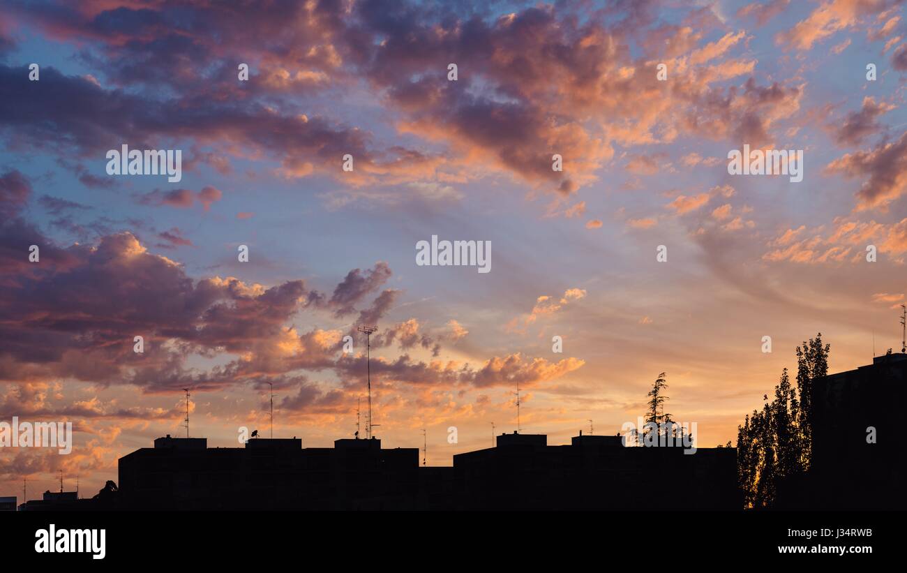 Colorful sunset clouds over apartments buildings in Madrid Stock Photo ...