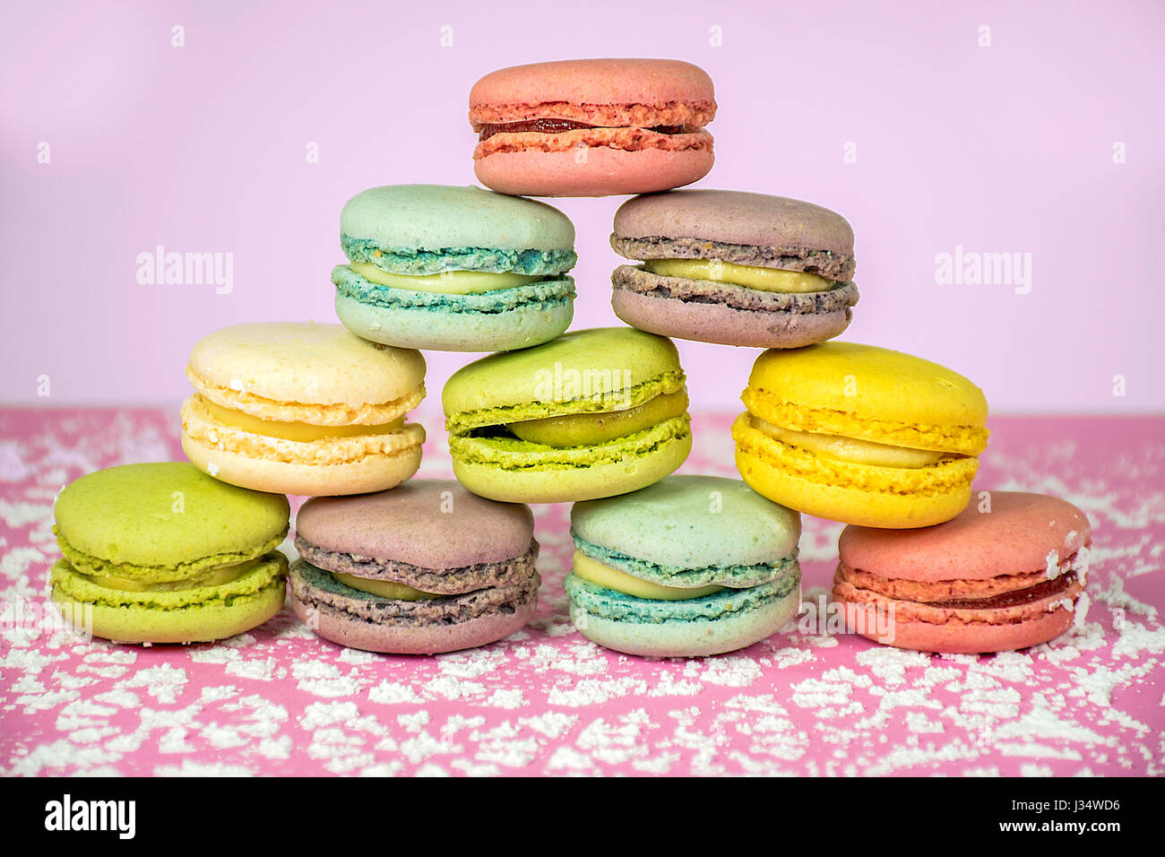 colorful French macaroon stack on powdered sugar design Stock Photo - Alamy