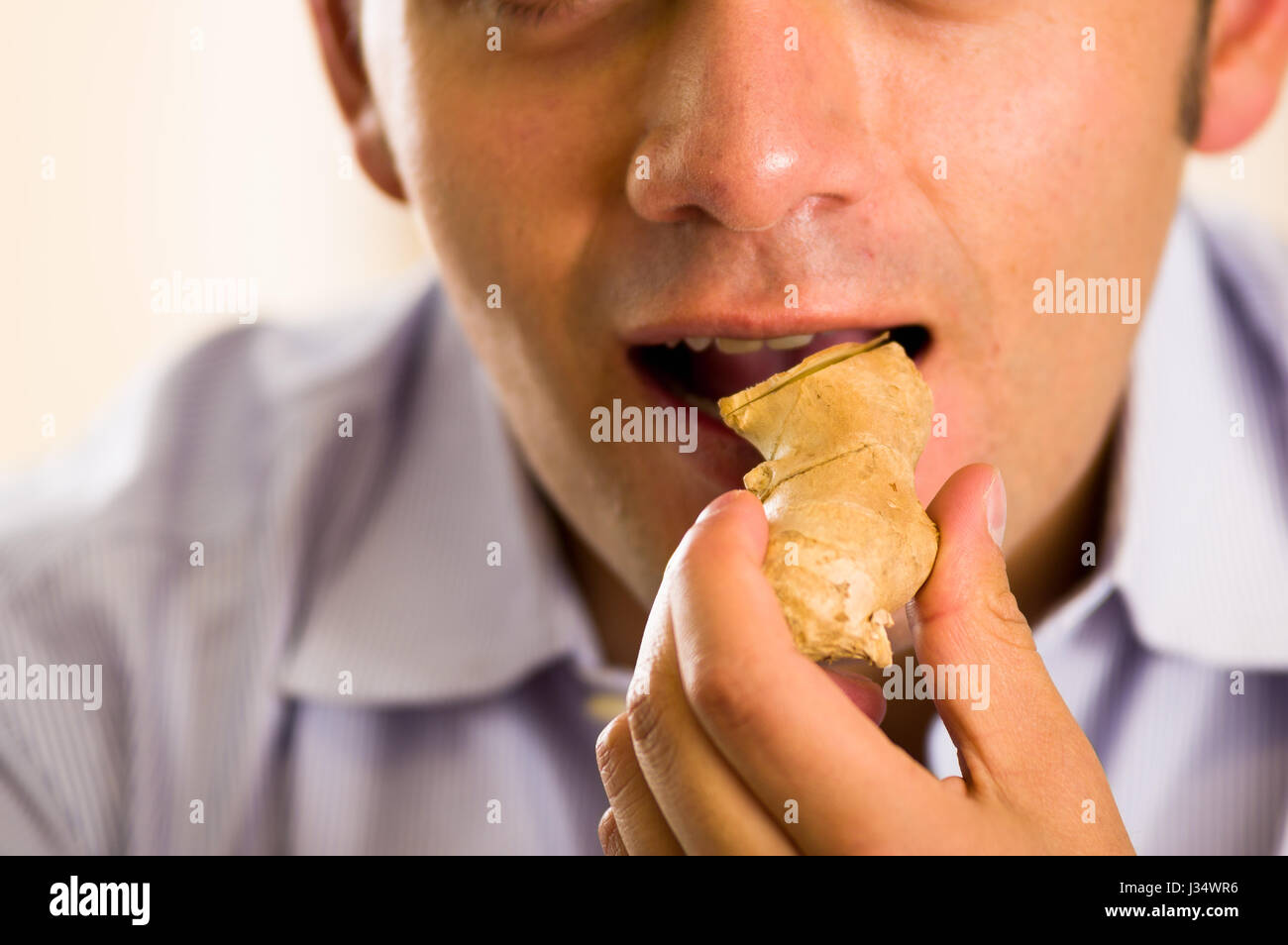 Handsome young man loves eat a piece ginger Stock Photo - Alamy