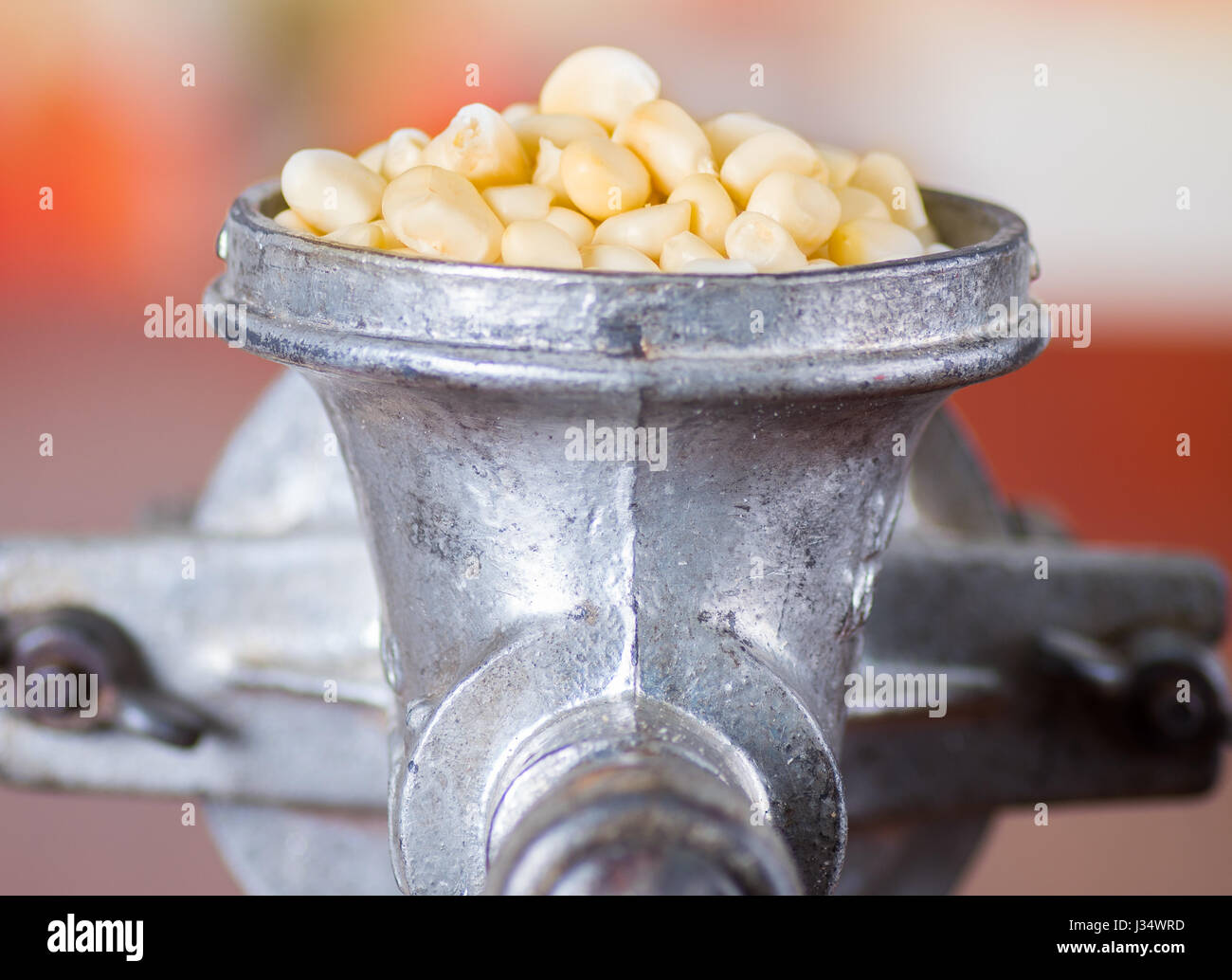 A close up from a metalic mill with some corn kernels Stock Photo - Alamy
