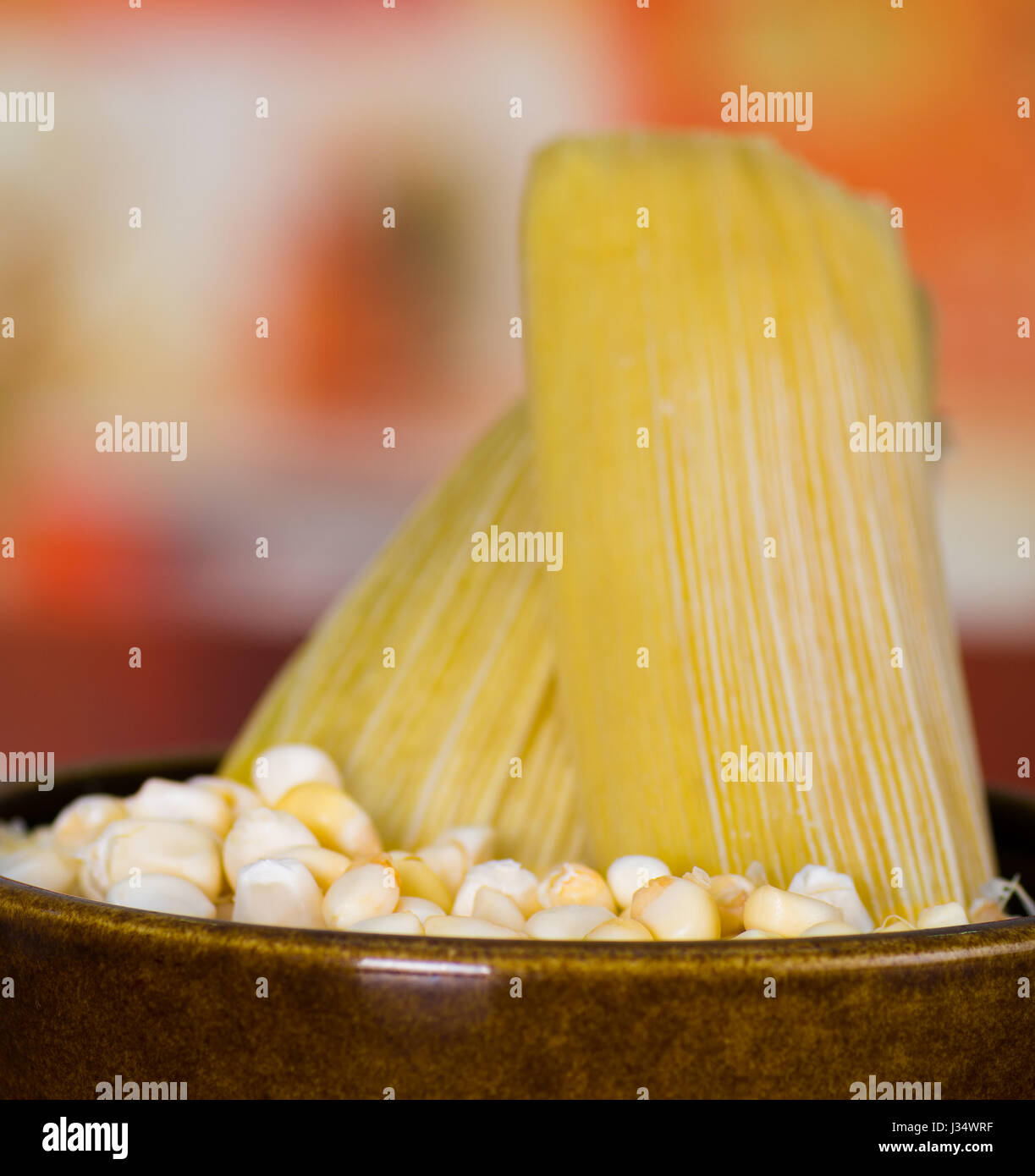 A yellow corn inside of a Crock pot with a couple of humitas Stock ...