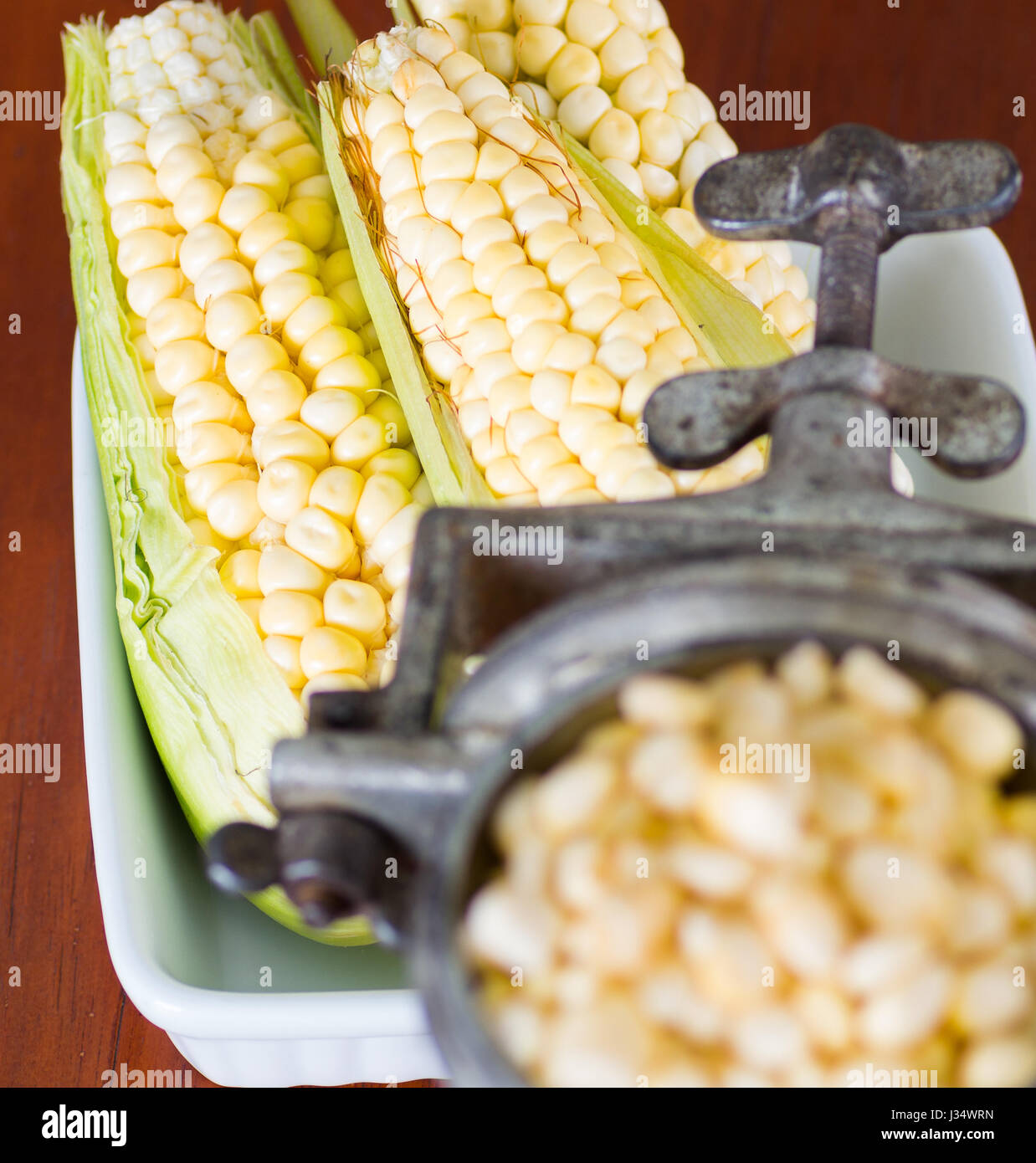 Milling corn for cattle feed inside a large shed Stock Photo - Alamy