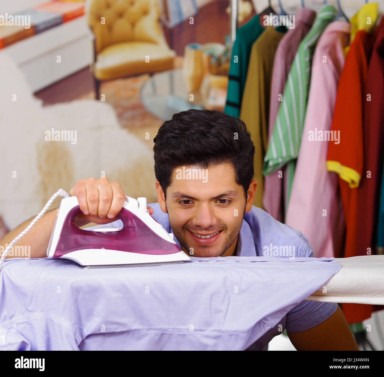 Close up of a Handsome young Man Ironing Clothes On Ironing Board Stock ...