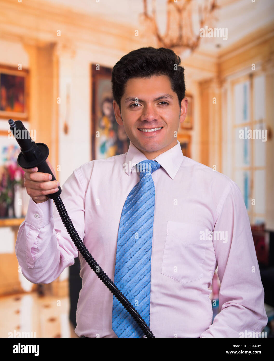Handsome young Man cleaning home with vacuum cleaner Stock Photo - Alamy