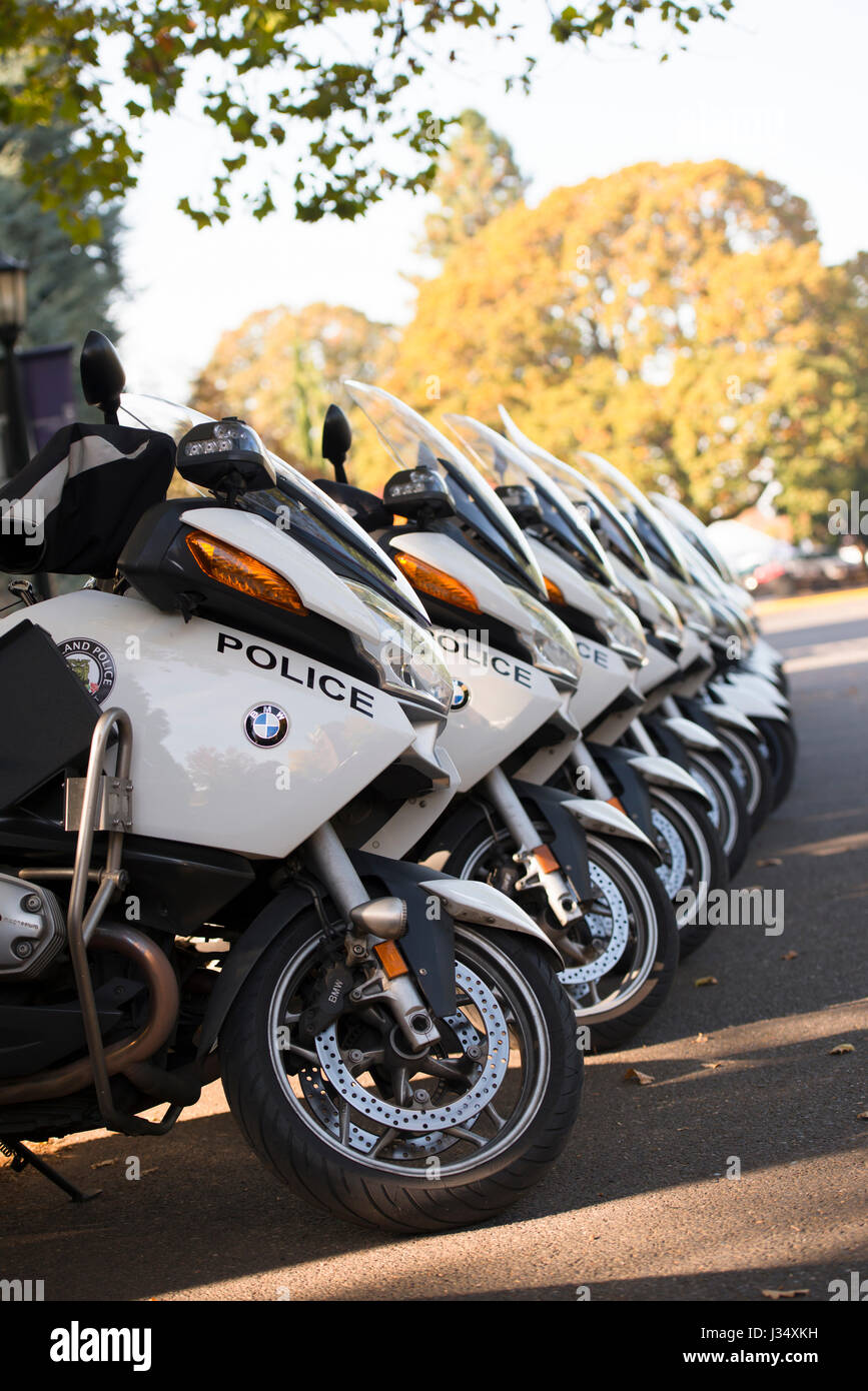 White modern police bikes line on the green and yellow trees background ...