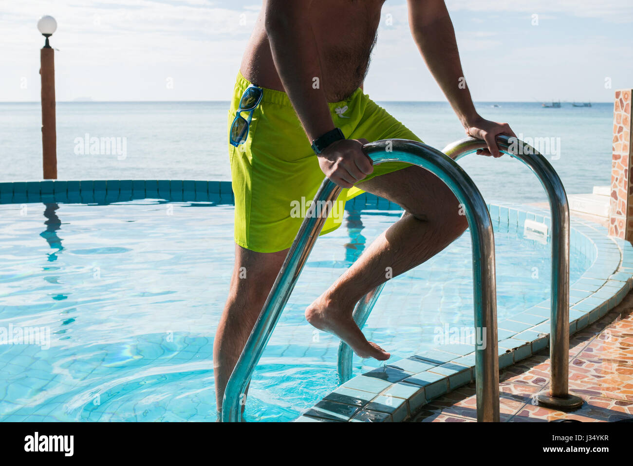 Young guy in outdoor pool Stock Photo - Alamy