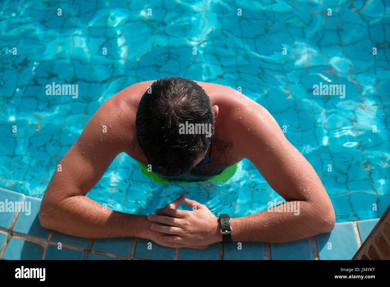 Man resting in outdoor pool Stock Photo - Alamy