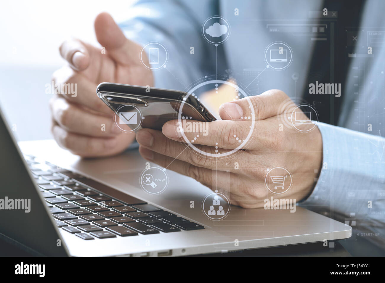 close up of businessman working with mobile phone and laptop computer ...