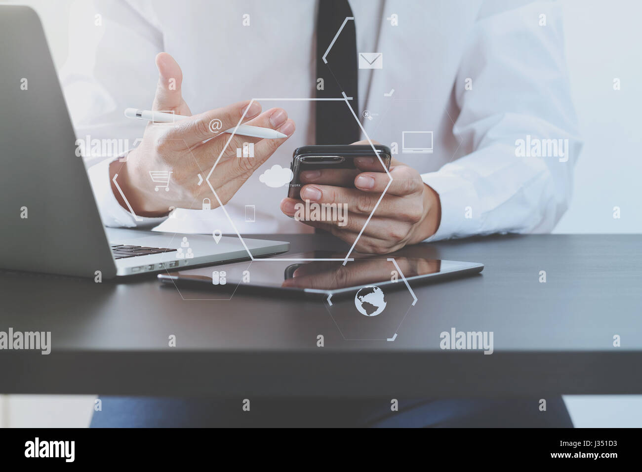close up of businessman working with mobile phone on wooden desk in ...