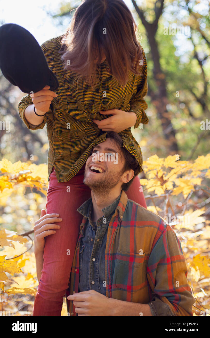 Young woman playfully sitting on her boyfriend's shoulders Stock Photo ...