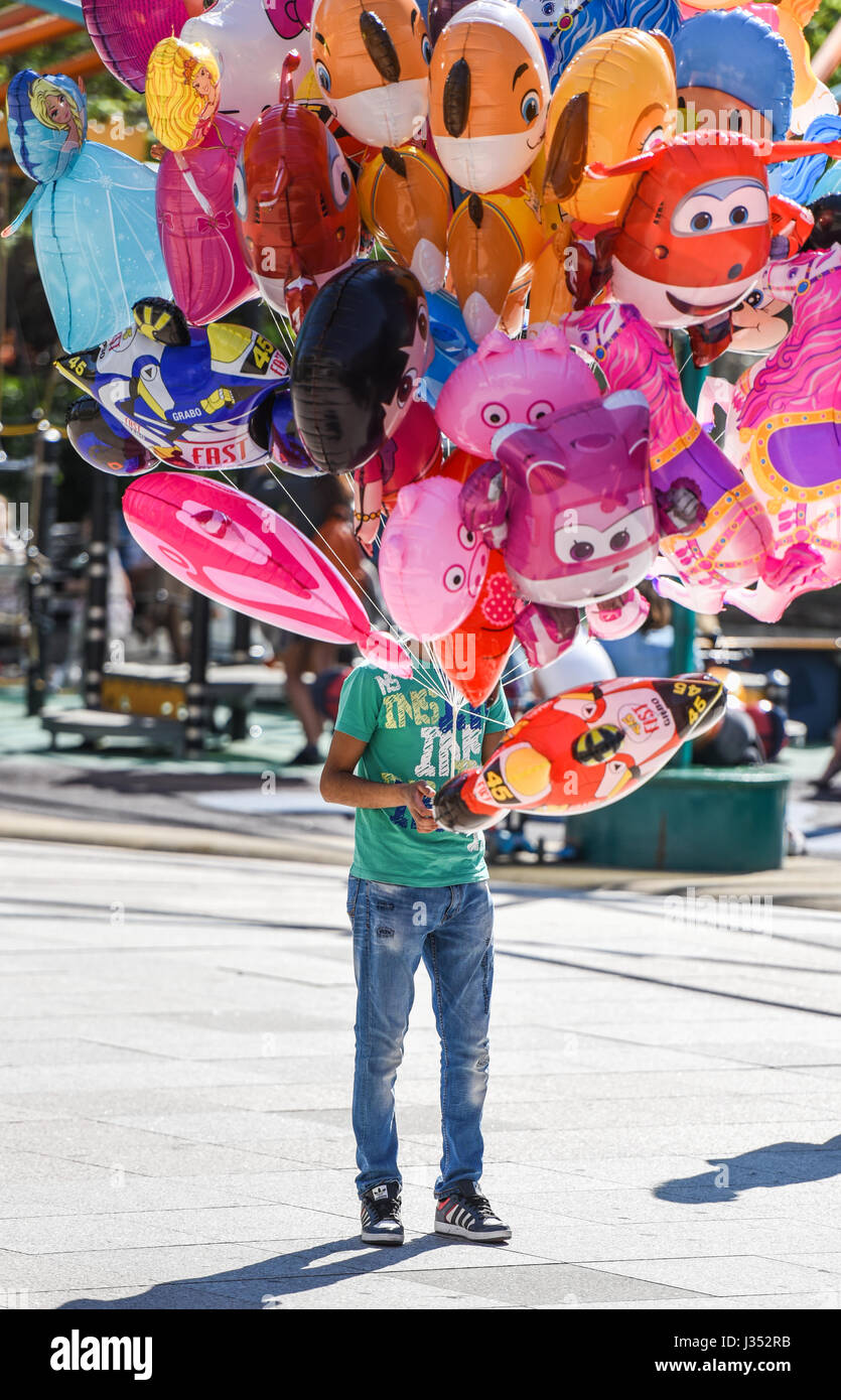Guy is selling colorful helium balloons Stock Photo - Alamy