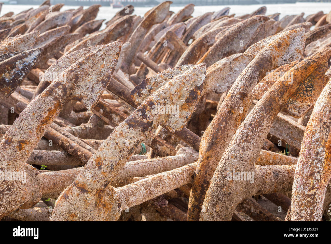 rusty old anchor in the port of Barbate, Cadiz, Spain. These anchors ...