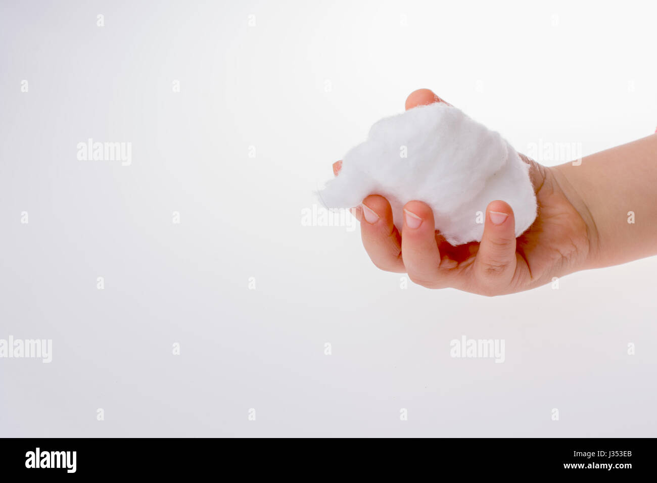 Hand holding some cotton in hand on a white background Stock Photo - Alamy