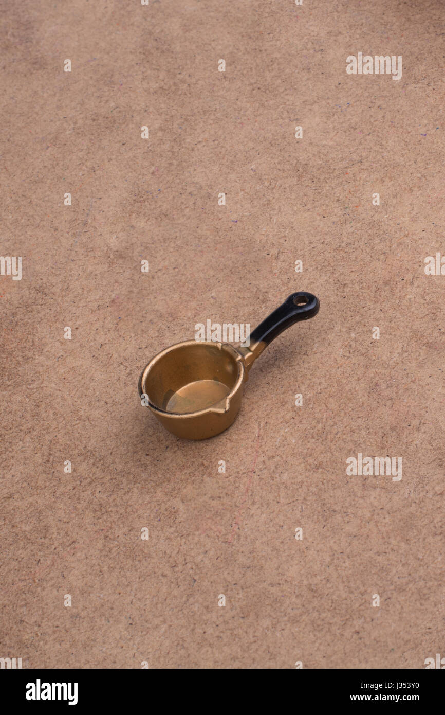 Little model pan of brown color as a kitchen utensil Stock Photo - Alamy
