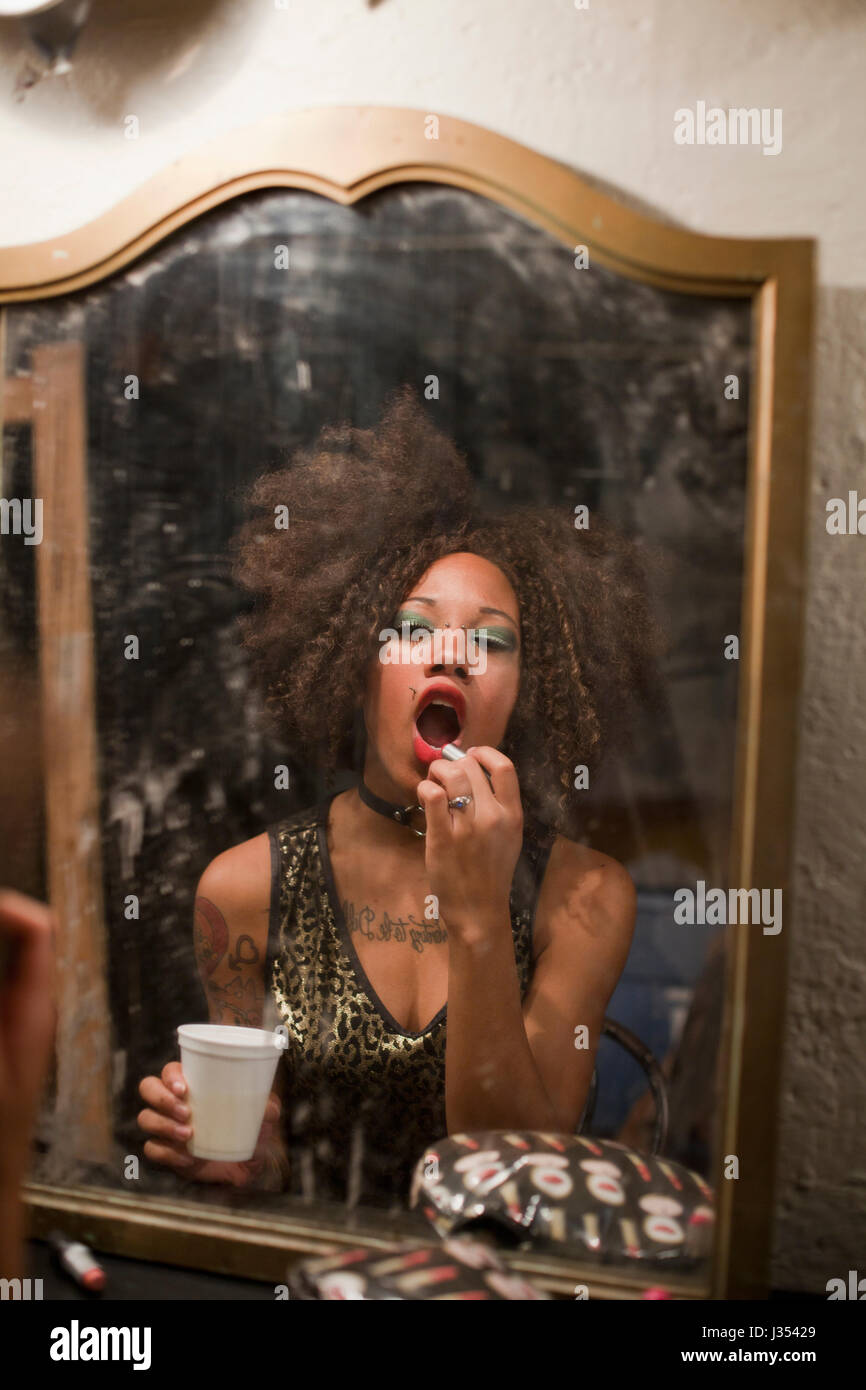 young woman looking into a mirror Stock Photo - Alamy