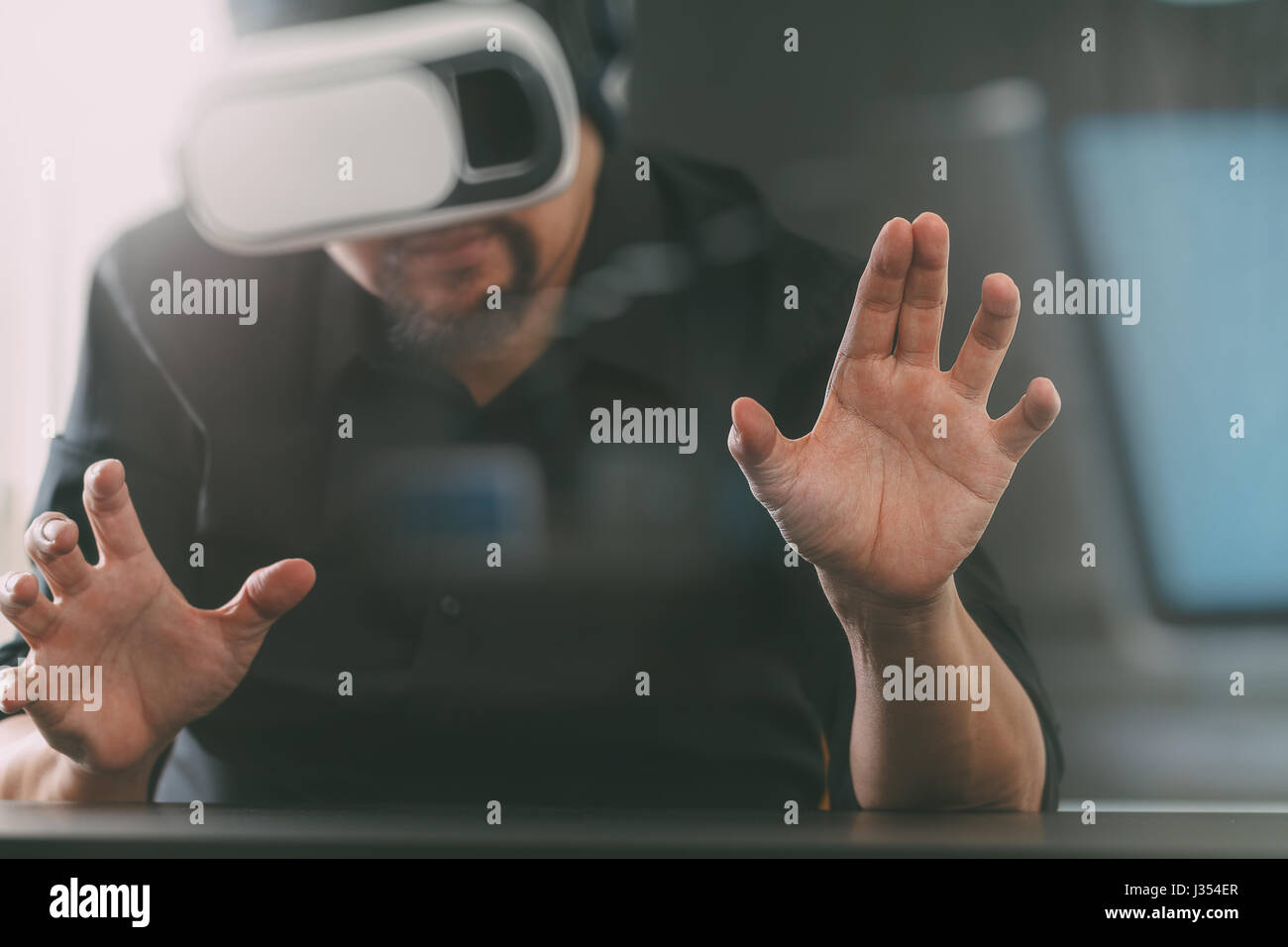 businessman wearing virtual reality goggles in modern office with ...