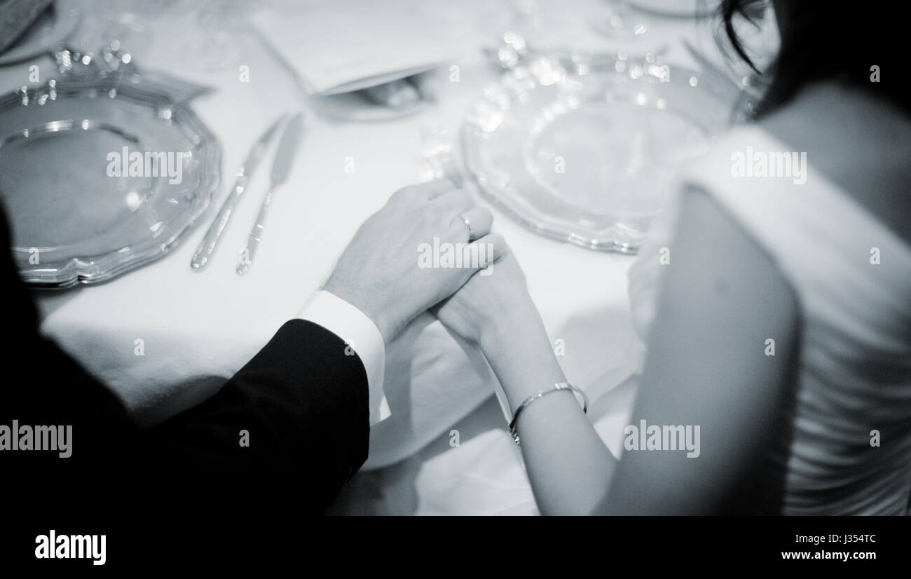 Wedding bride in bridal gown dress and groom in suit holding hands in ...