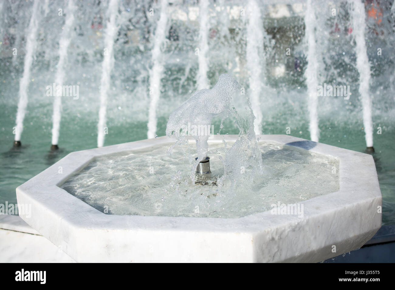 The fountains gushing sparkling water in a pool in a park Stock Photo ...