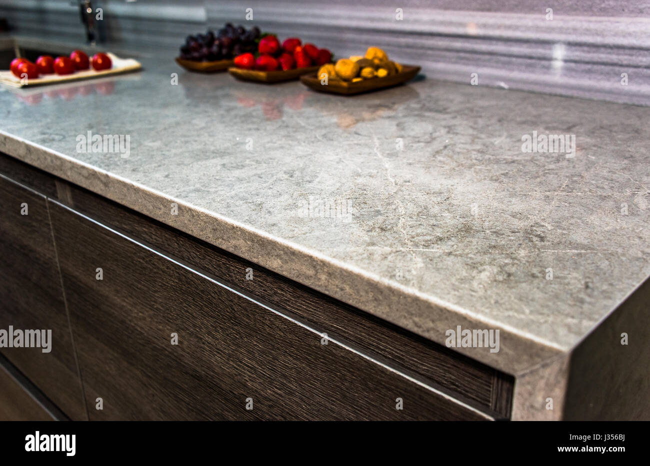 Modern kitchen perspective view of granite countertop and fruits on it ...