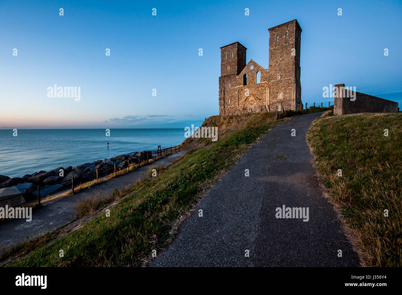 Reculver towers on the North Kent coast lit up at twilight Stock Photo ...
