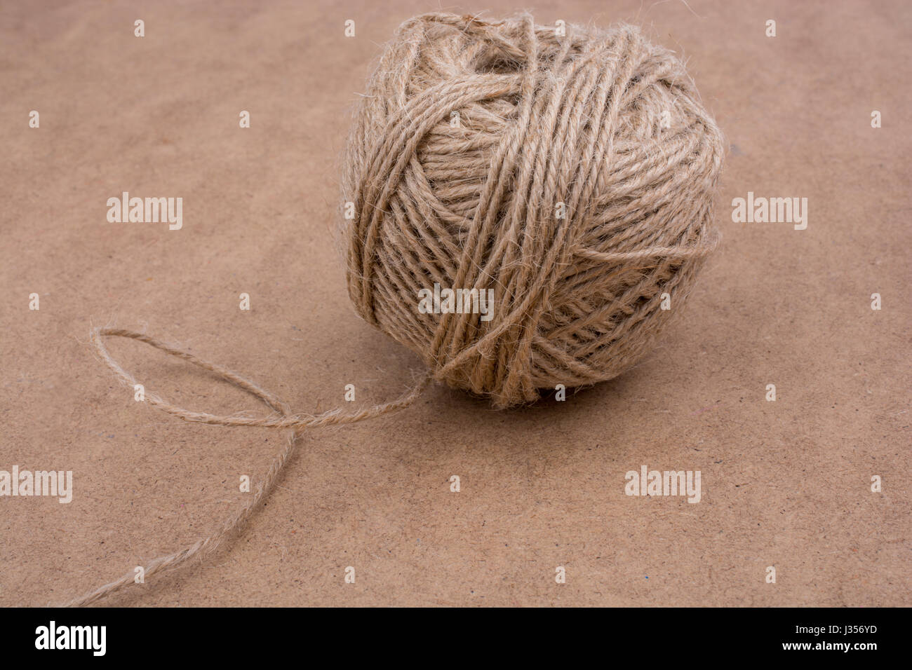 Roll of brown color linen string on brown background Stock Photo - Alamy