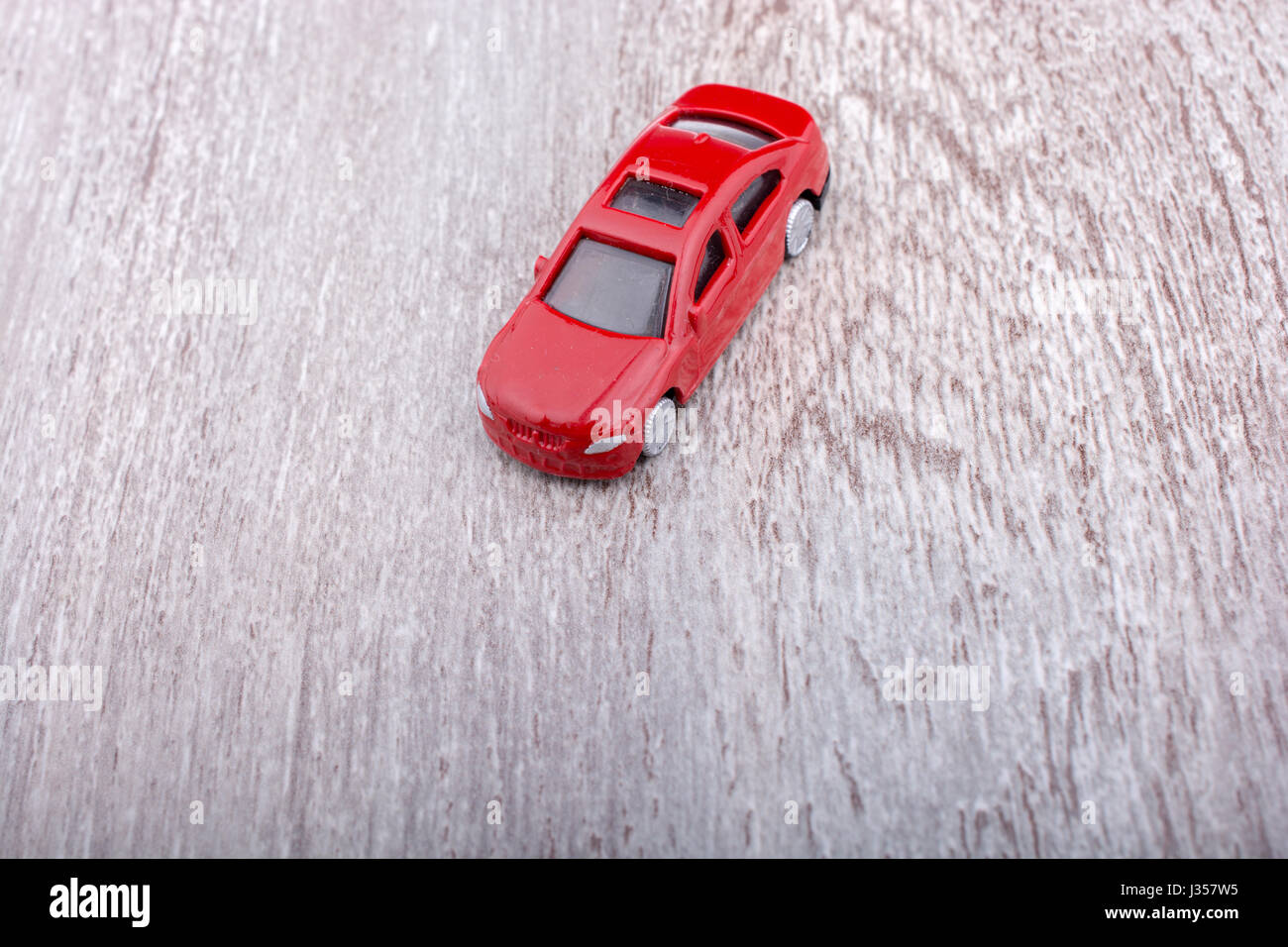 Colorful little toy car on a grey background Stock Photo - Alamy
