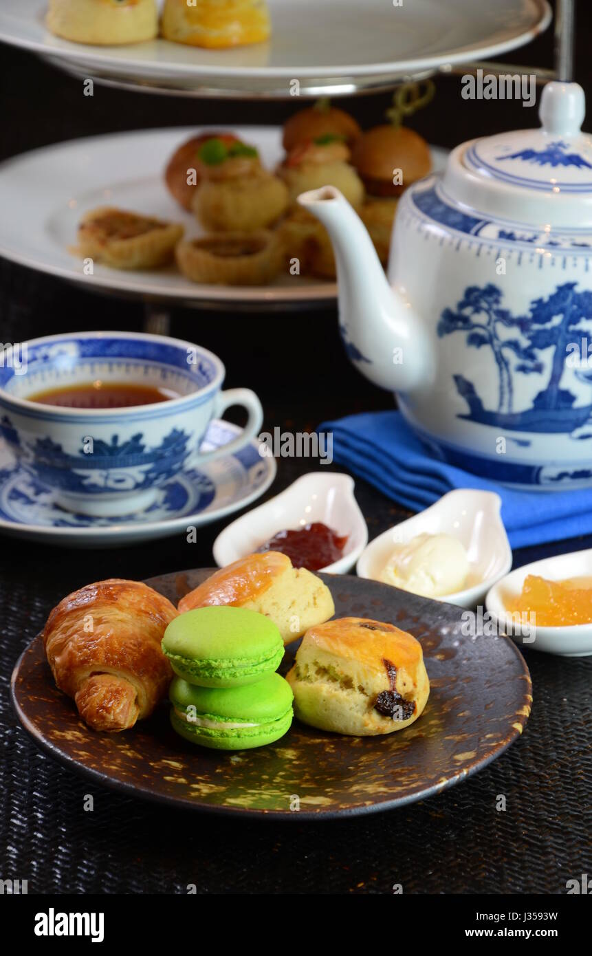 Scone and macaroon with sweet sauce afternoon tea set Stock Photo - Alamy