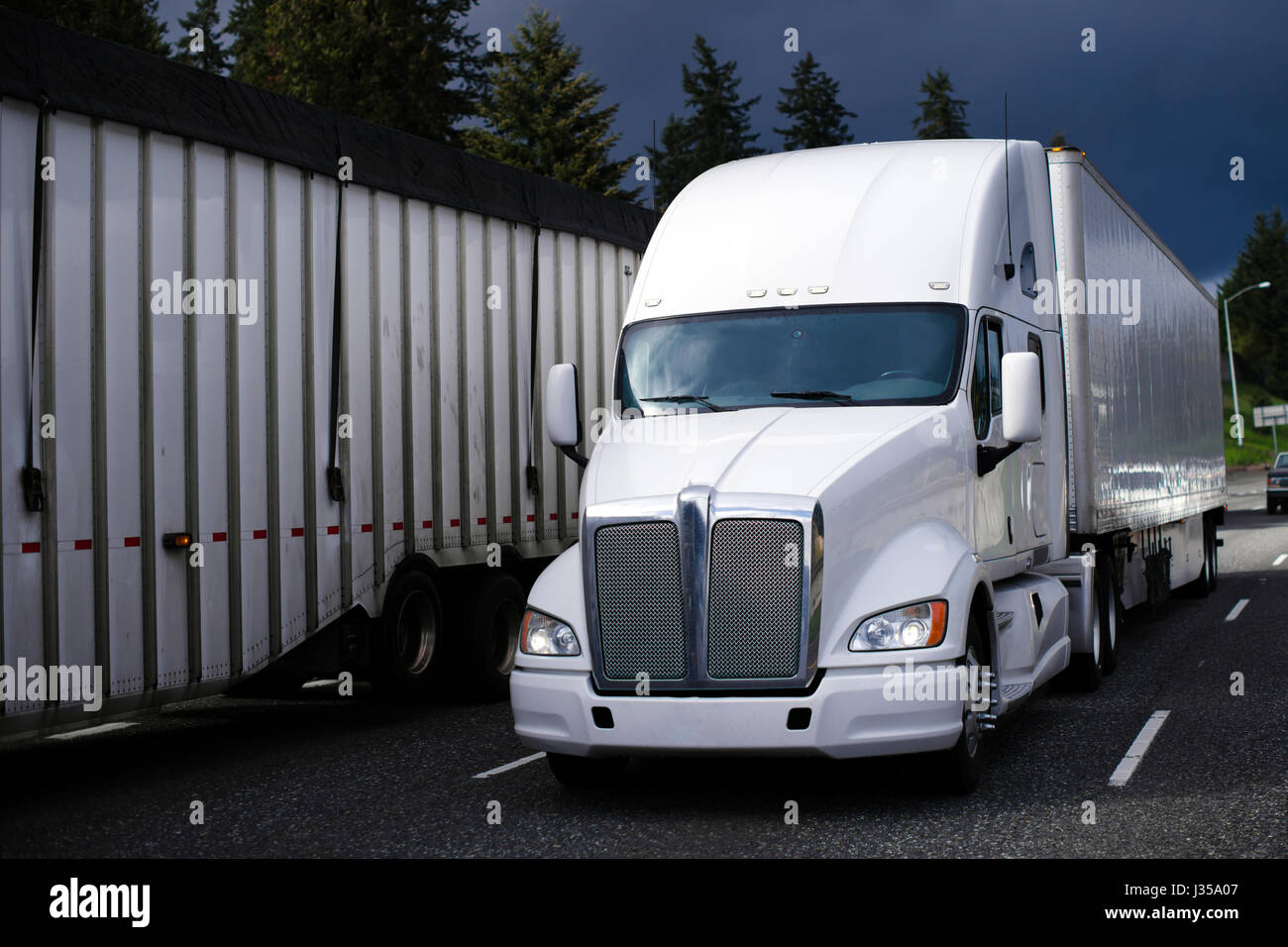 Modern American production bonneted model white big rig semi truck ...