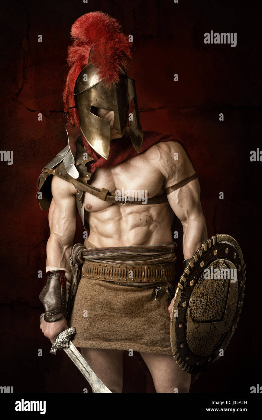 Ancient warrior or Gladiator posing over a dark background Stock Photo ...
