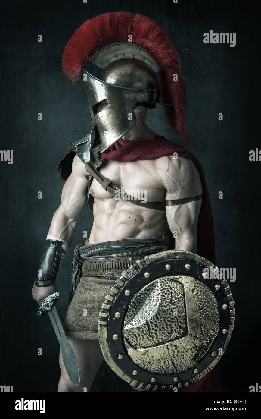 Ancient warrior or Gladiator posing over a dark background Stock Photo ...