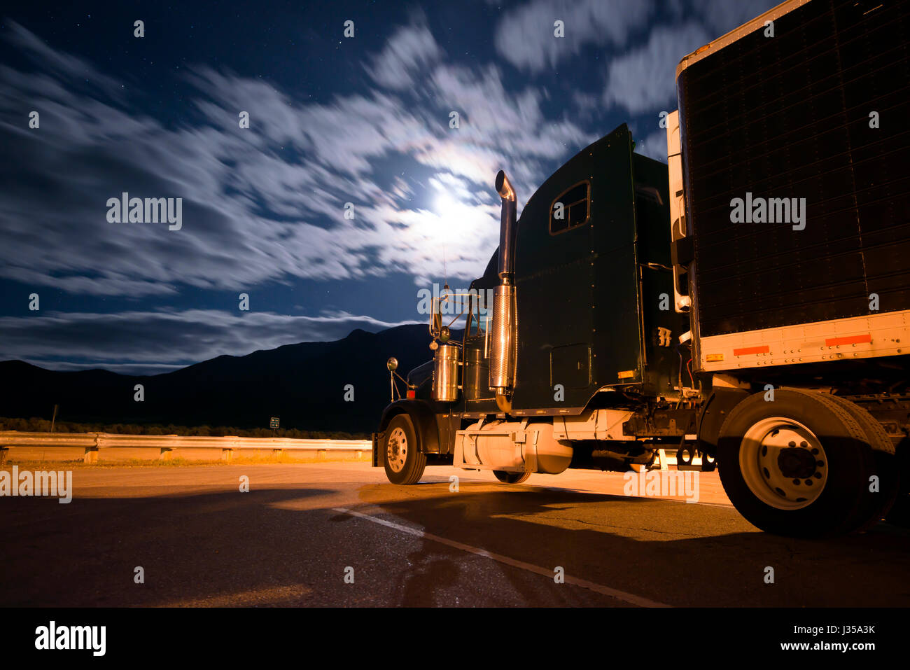 Colorful picture of a black semi truck and a reefer trailer standing in ...