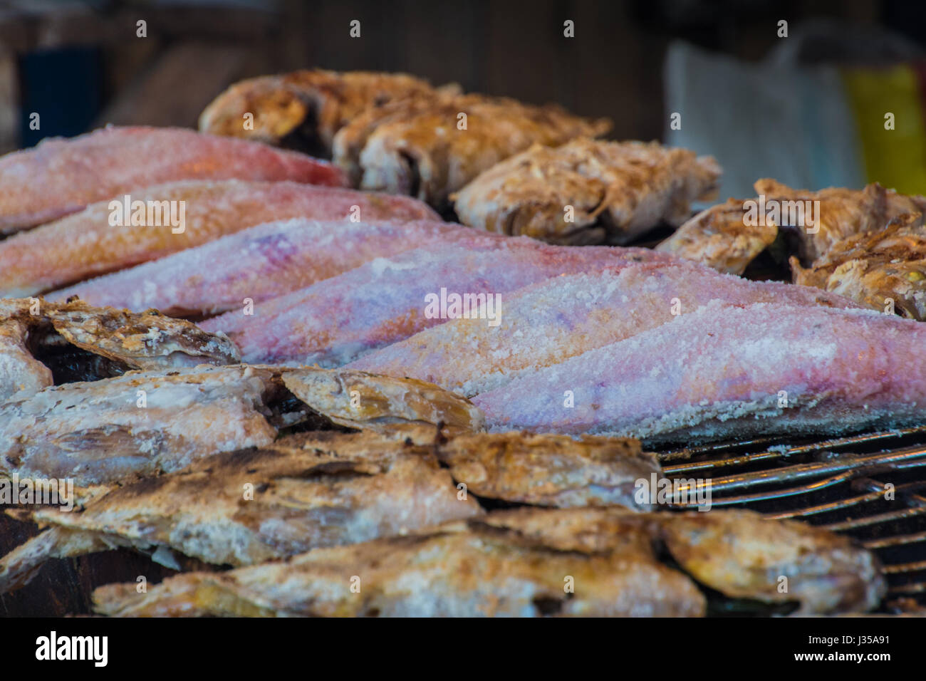 Exotic fish being grilled red and brown Stock Photo - Alamy