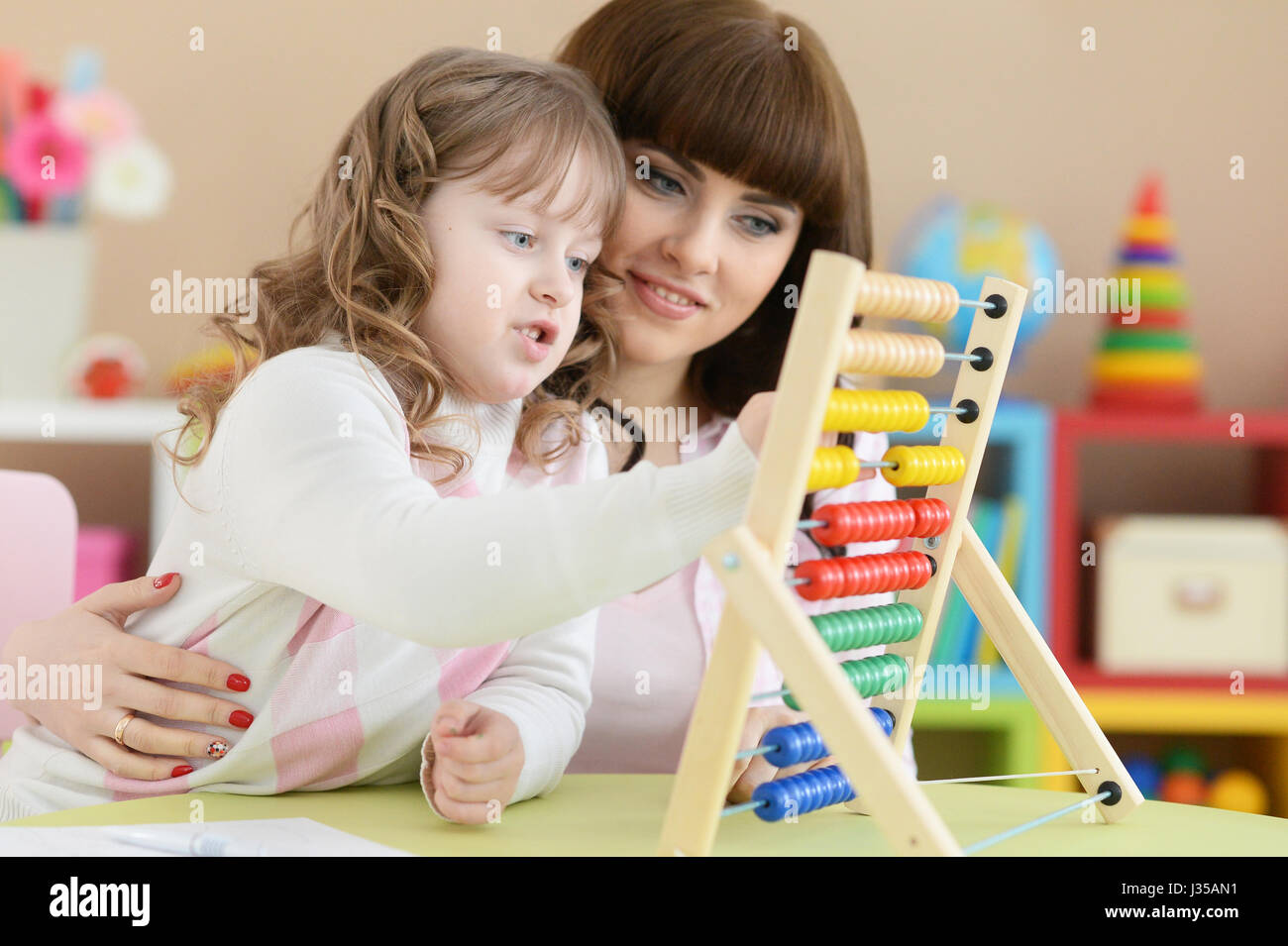 Mother and daughter doing lessons Stock Photo - Alamy