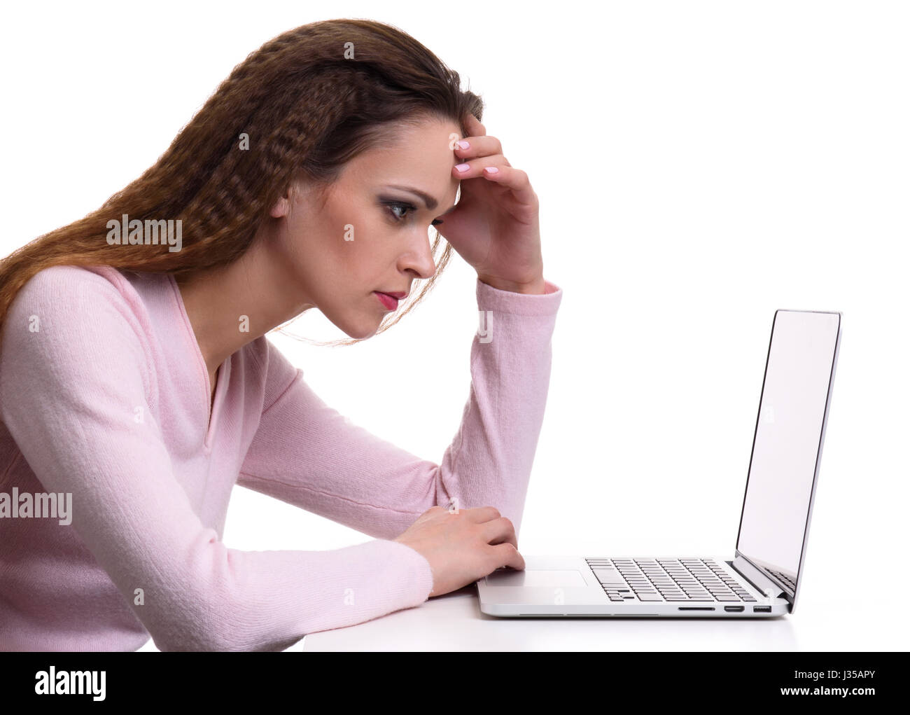 pretty girl working on laptop computer at the desk. Isolated Stock ...