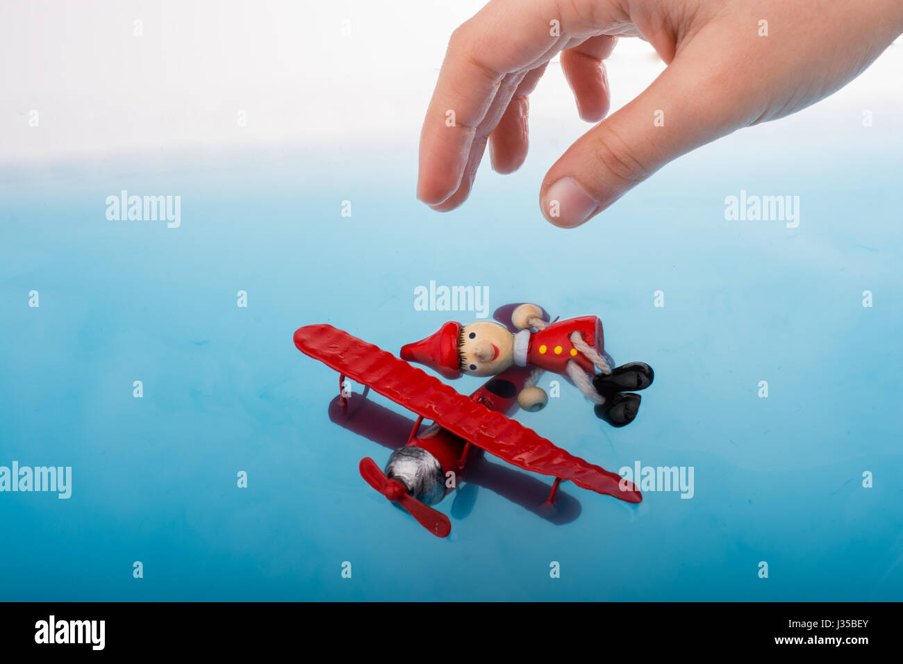 Pinocchio and a model airplane in water Stock Photo - Alamy