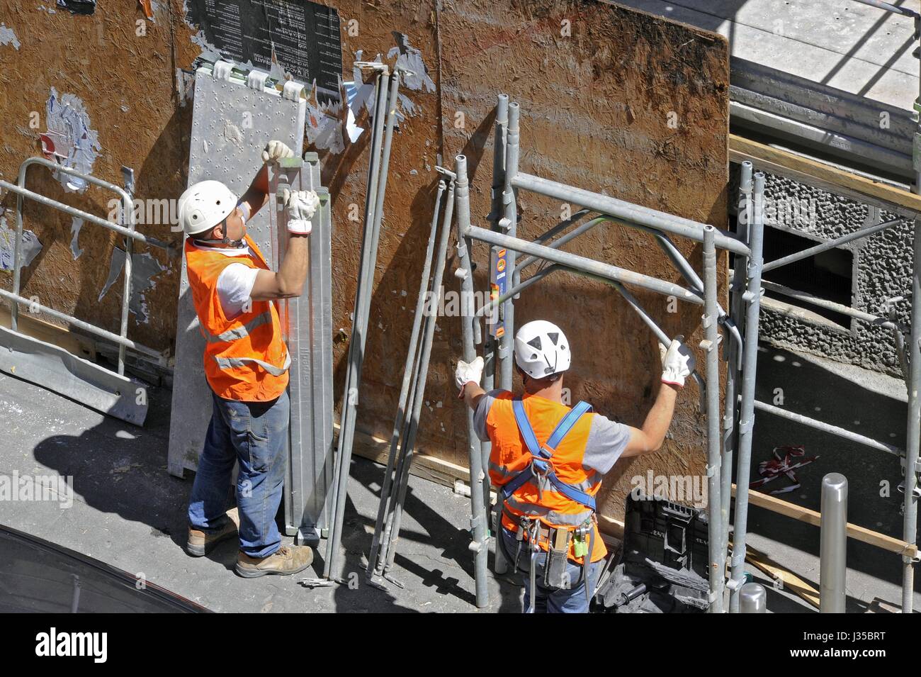 Construction workers on the scaffolding for the renovation of a ...