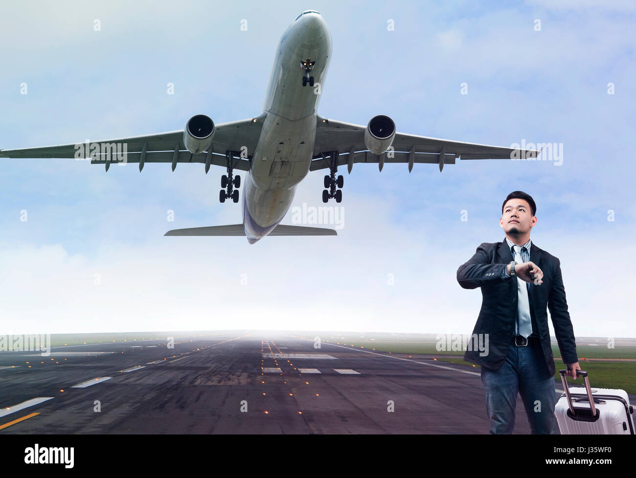 young business man standing in airport runways with belonging luggage ...