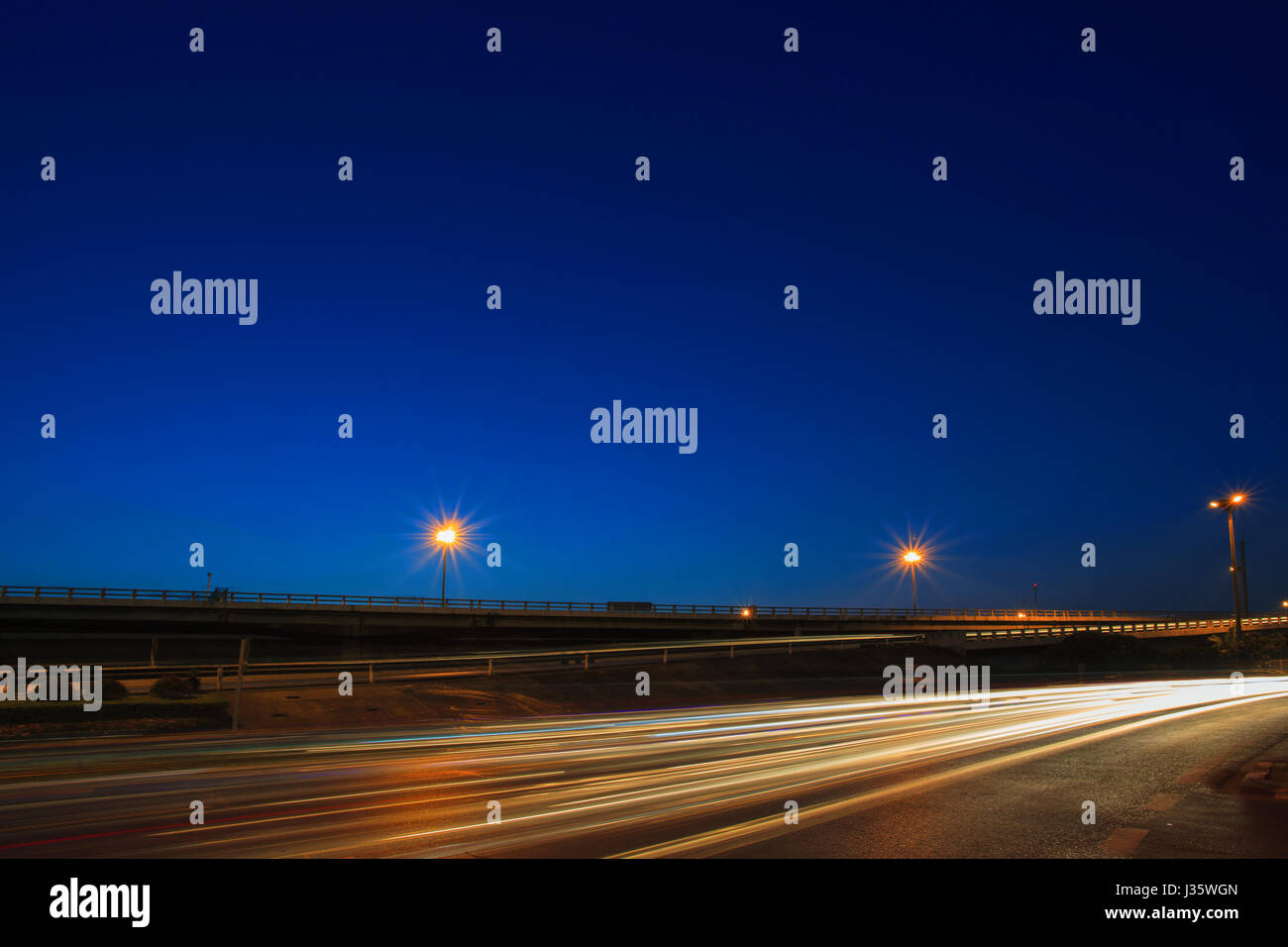 lighting of vehicle driving on asphalt road against beautiful blue ...