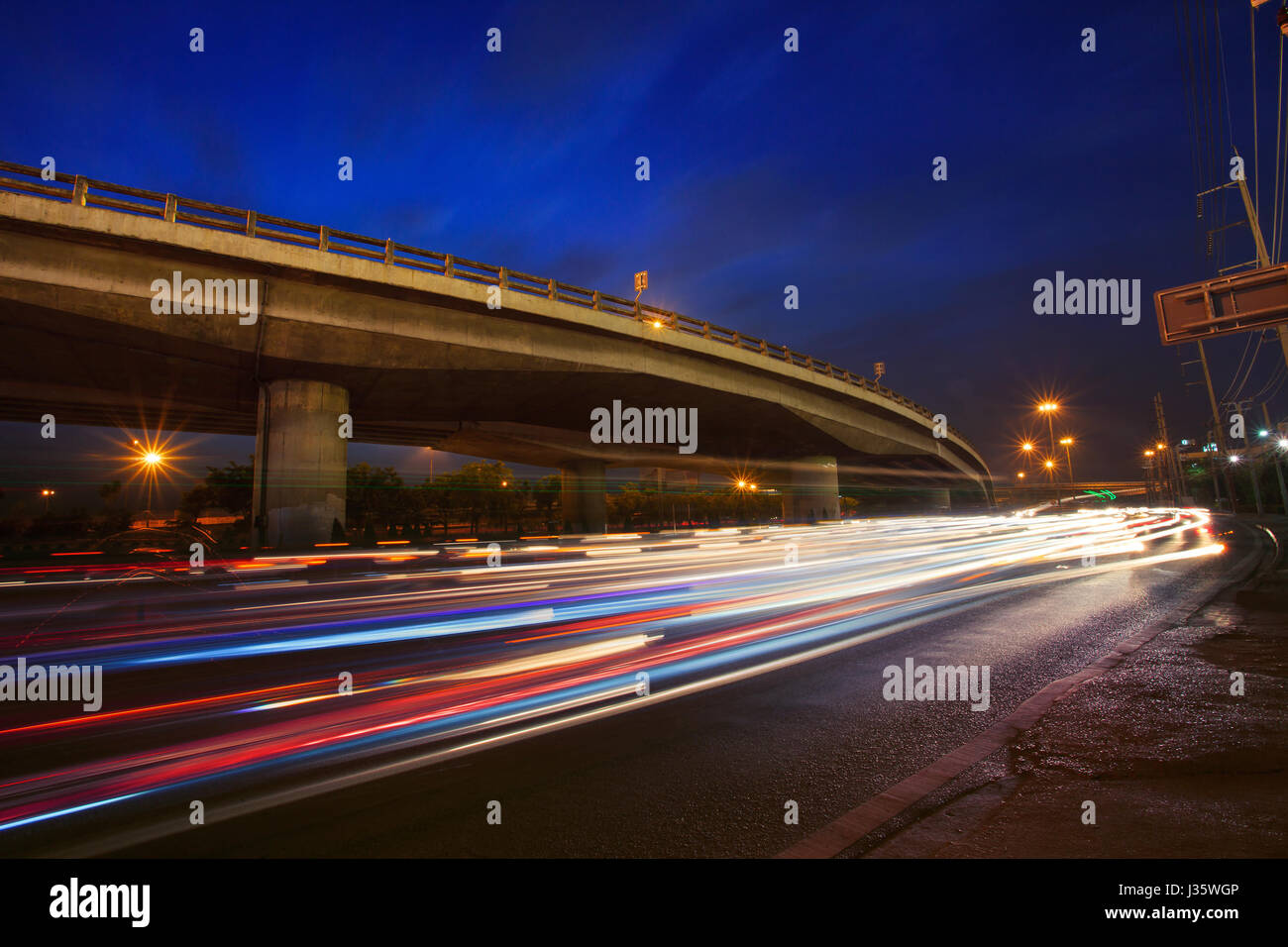 traffic lighting on rush hour road and express ways bridge against ...