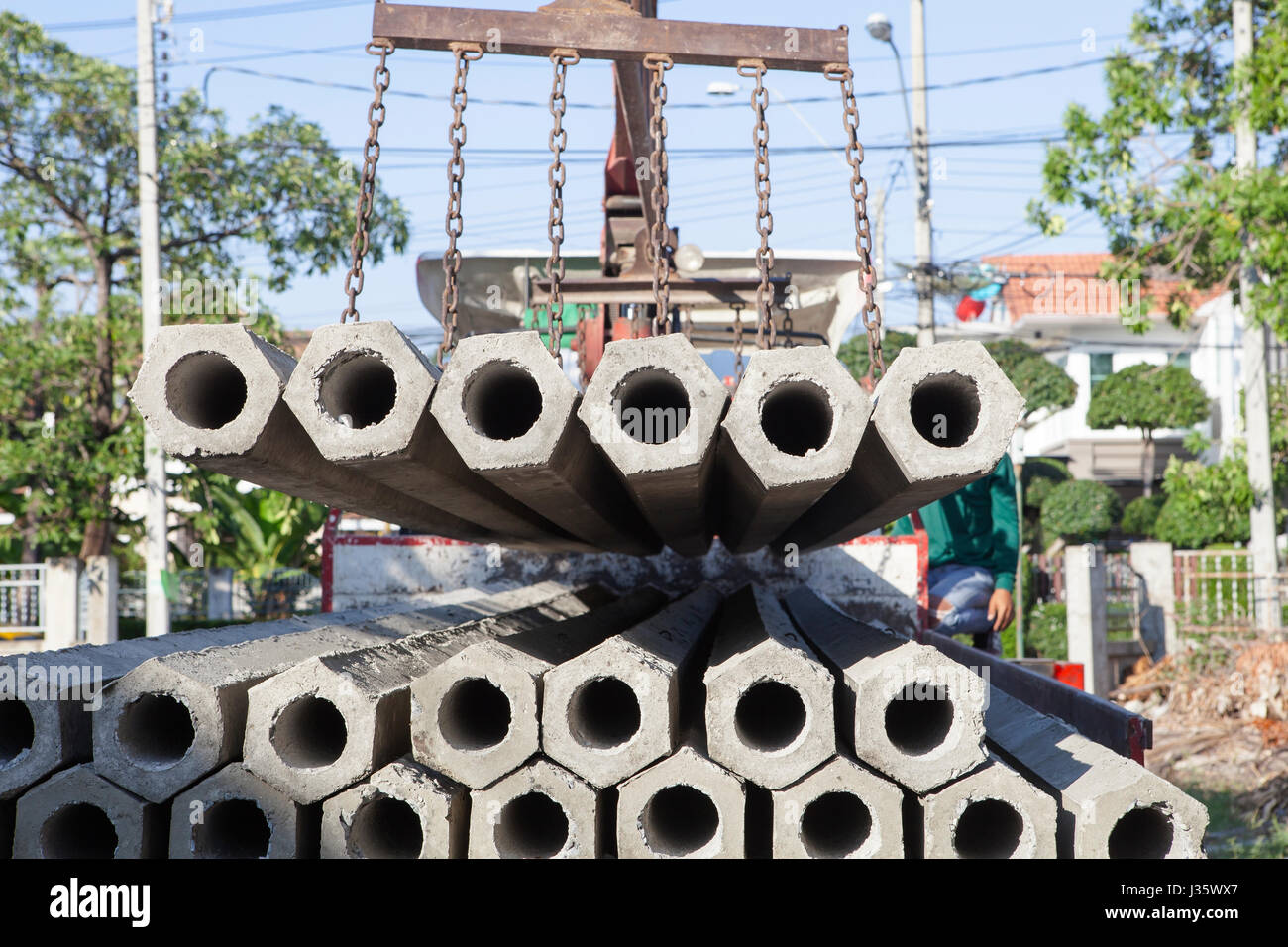 construction concrete root pole on lifting crane preparing to ...