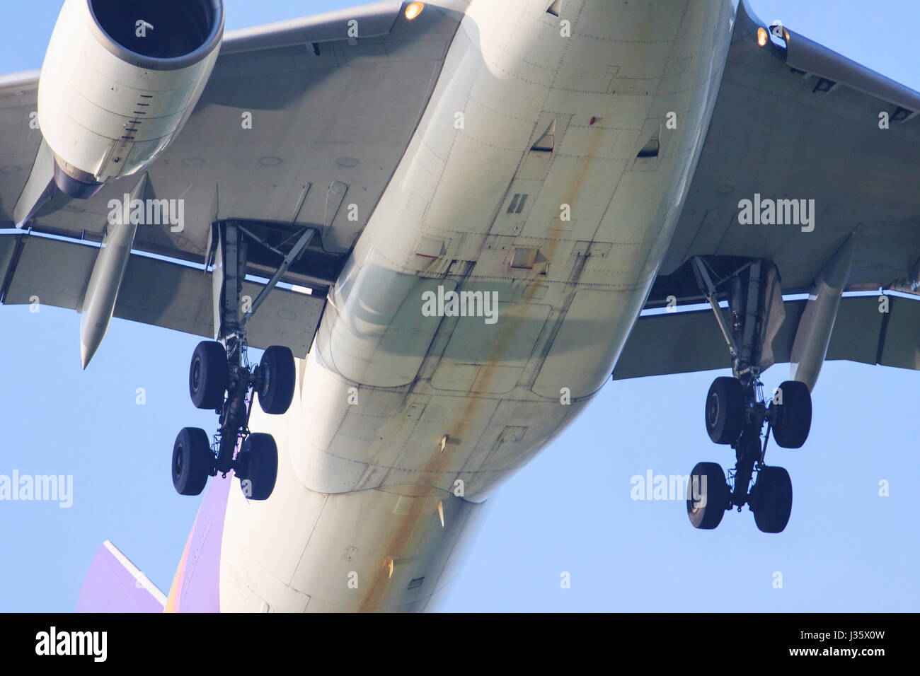 close up of bottom view of passenger jet plane show driving wheel and ...