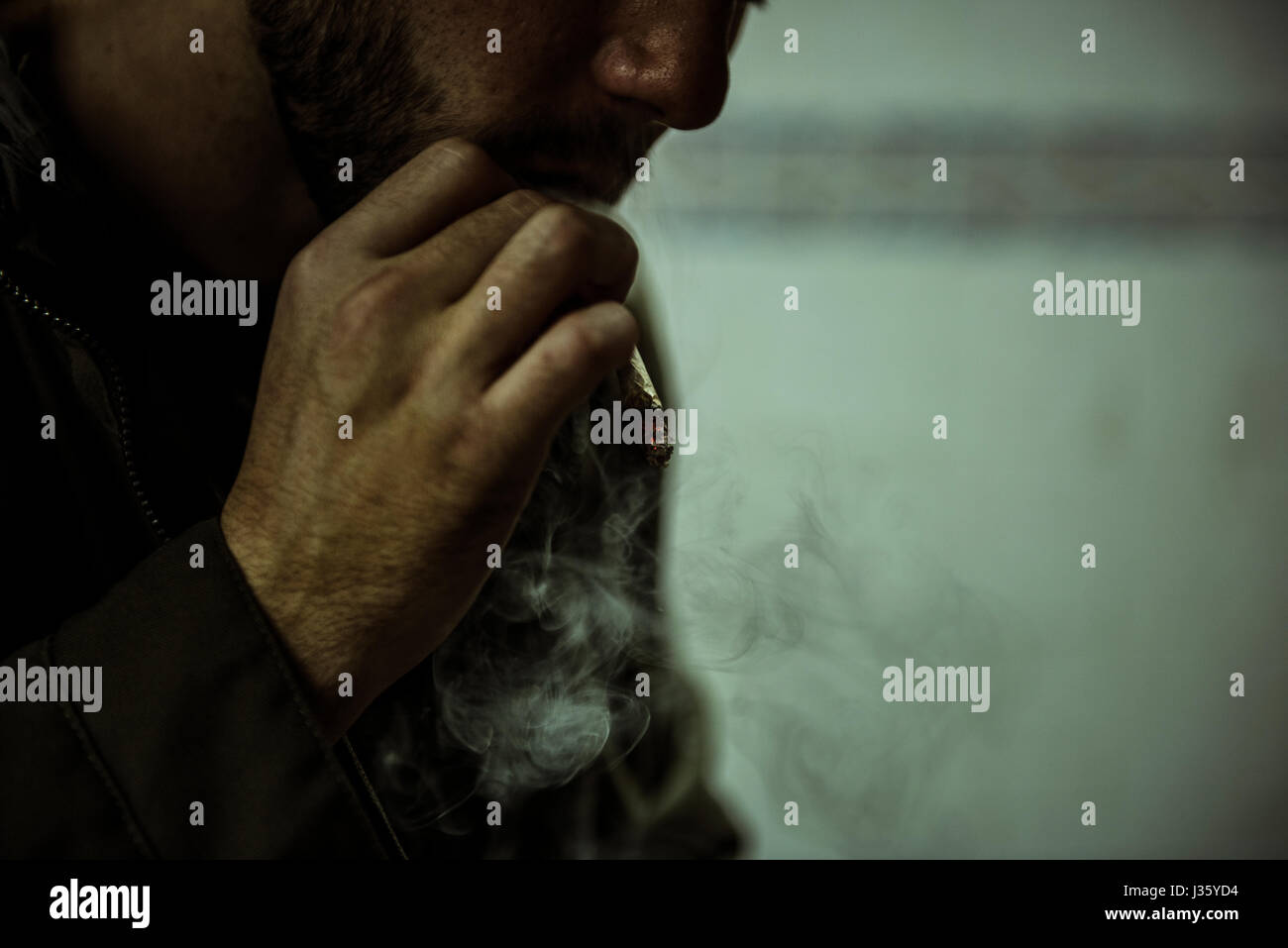 Homeless man smoking cigarette hi-res stock photography and images - Alamy